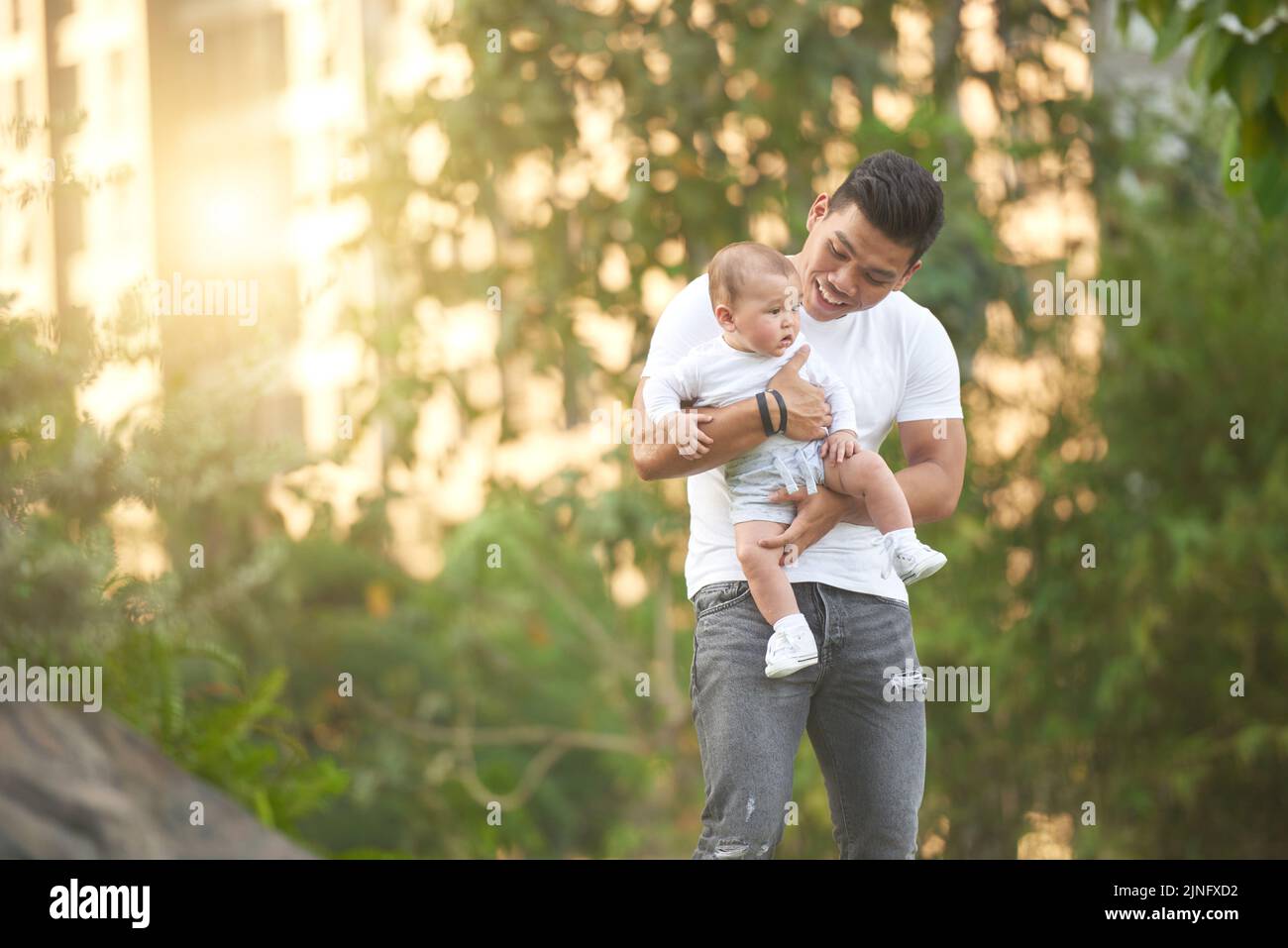 Happy young father walking with his little kid Stock Photo - Alamy