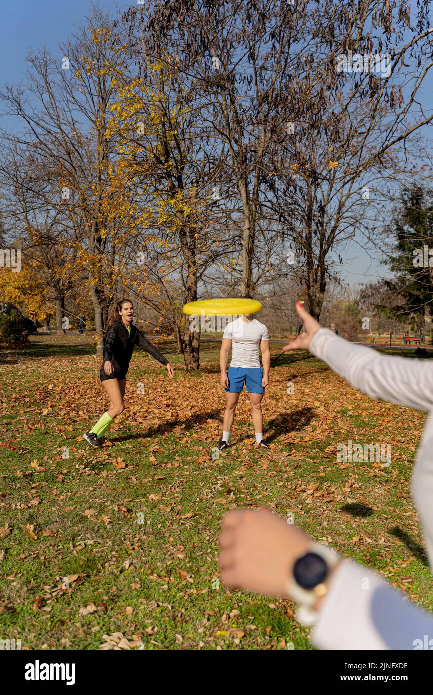 Three attractive and amazing fit friends are playing frisbee Stock ...