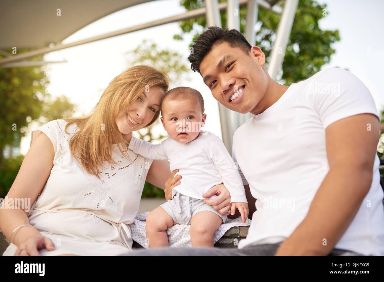 Joyful multi-ethnic parents and their little baby Stock Photo - Alamy