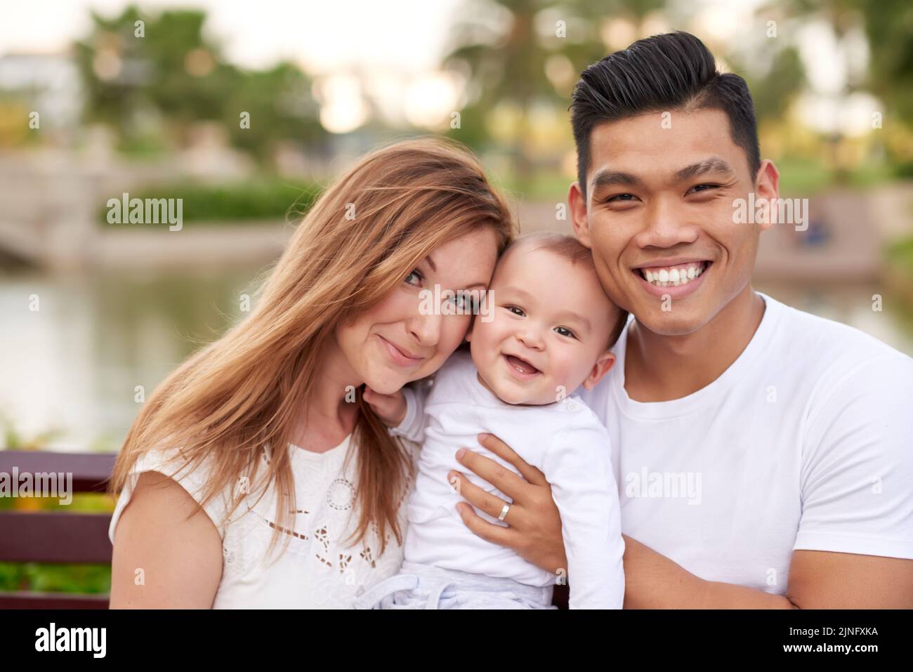 Asian father hugging baby hi-res stock photography and images - Alamy
