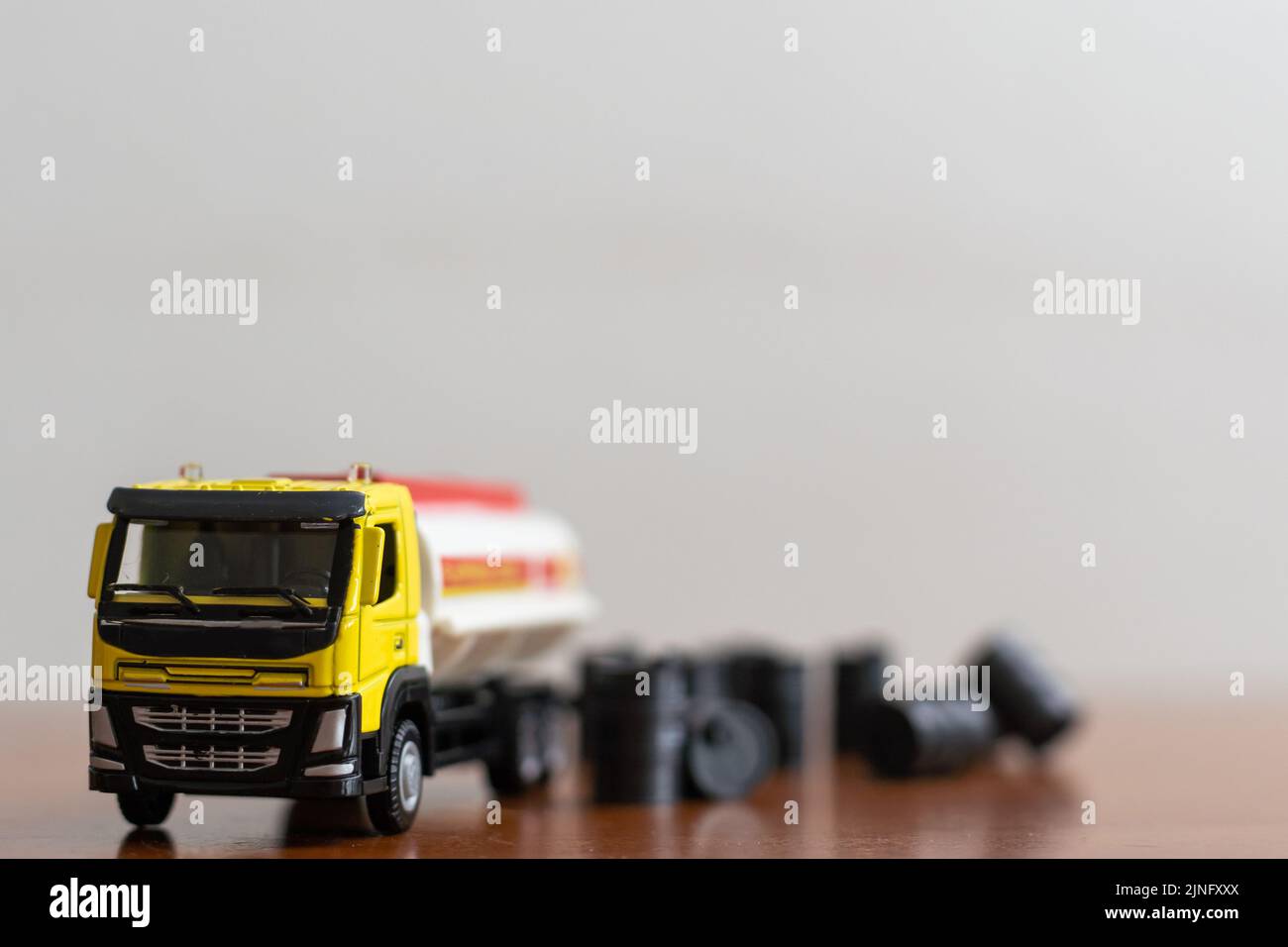 small toy combine with toy oil barrel Stock Photo - Alamy