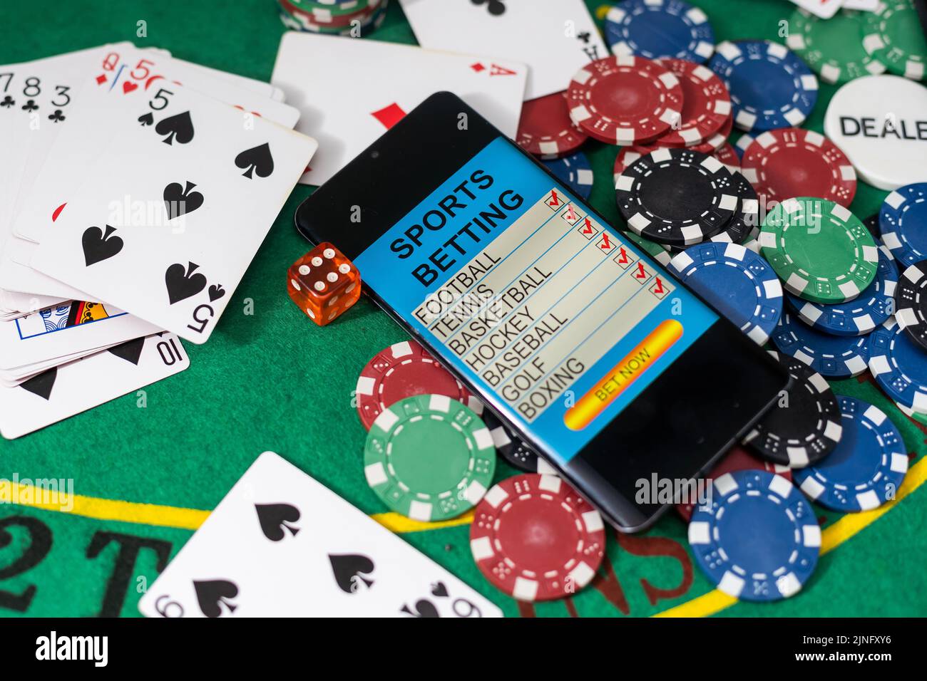 Smartphone with poket table on screen, playing cards and chip cards on ...
