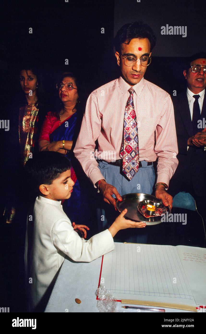 Father and Son Holding Diya over Red Chopdis Performing Chopda Puja ...