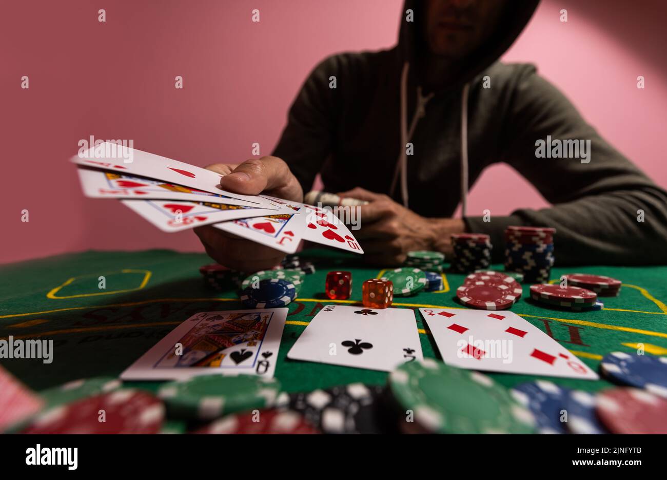 Happy poker player winning and holding cards Stock Photo - Alamy