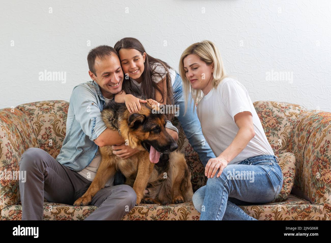 Portrait of happy family with a dog having fun together at home Stock ...