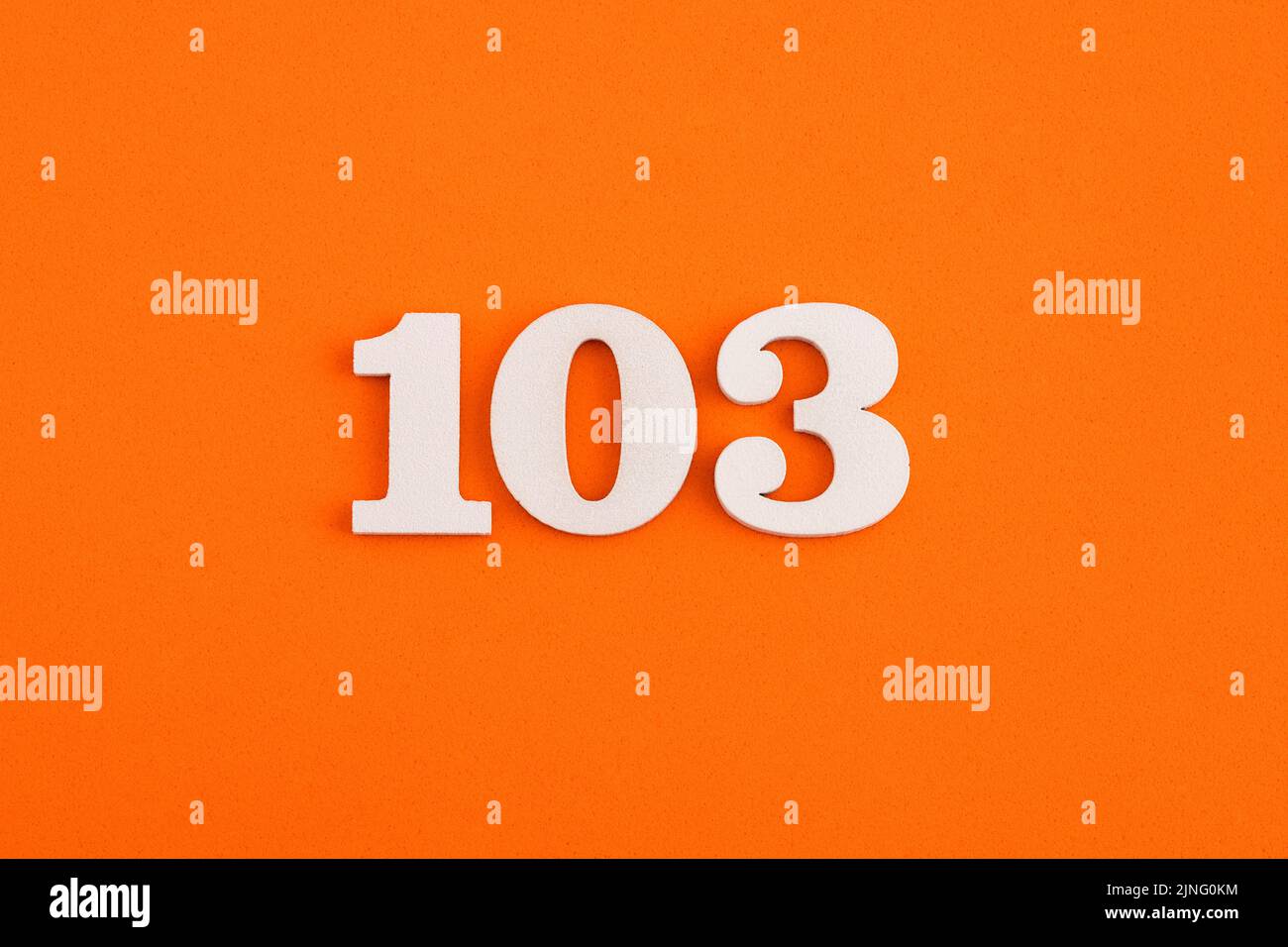 Number 103 - On orange foam rubber background Stock Photo - Alamy