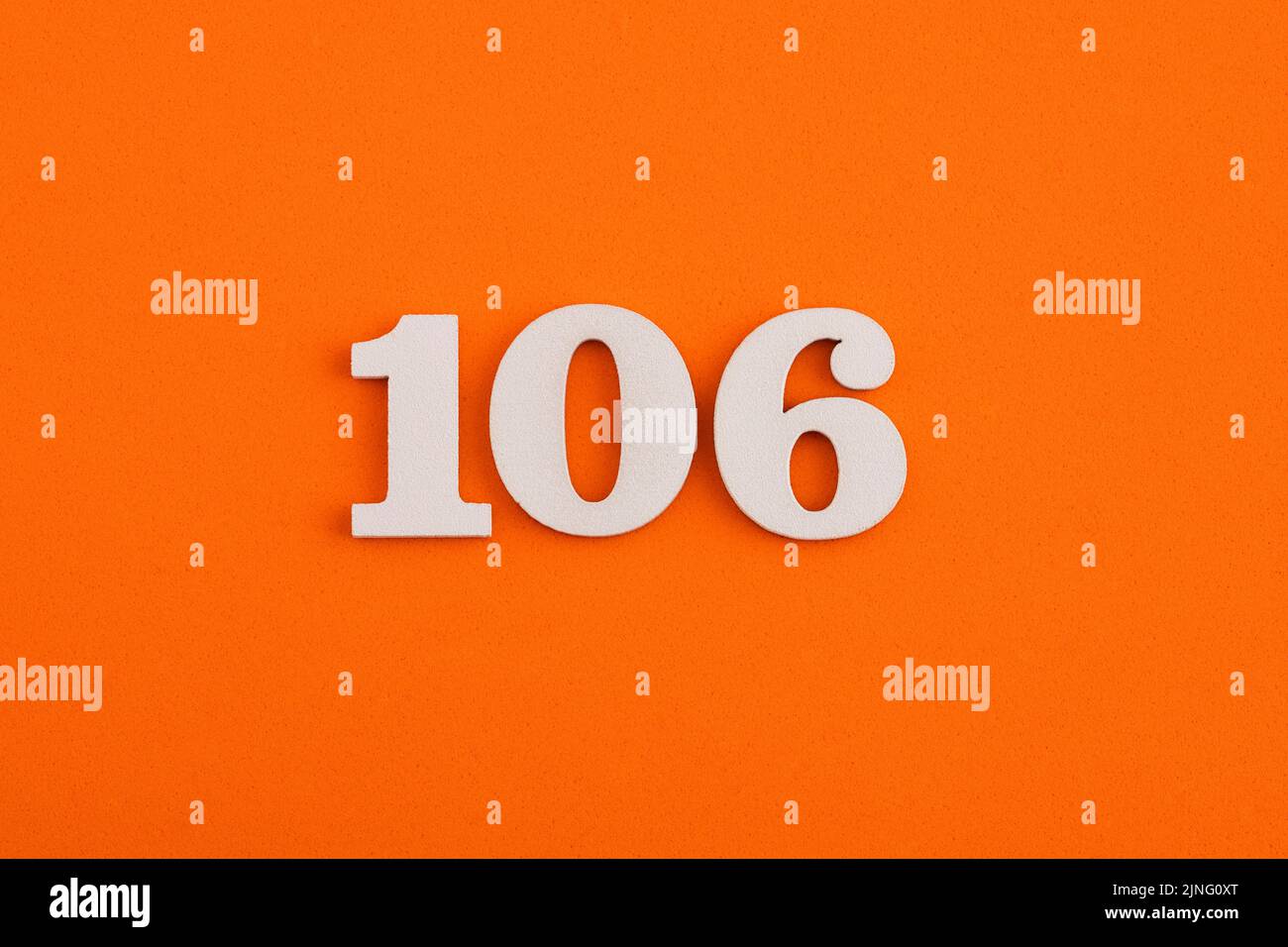 White wooden number 106 on eva rubber orange background Stock Photo - Alamy