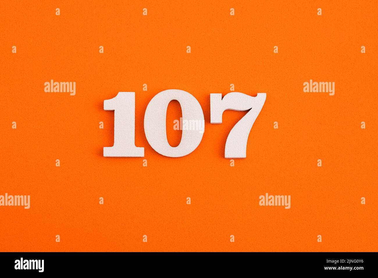 Number 107 - On orange foam rubber background Stock Photo - Alamy