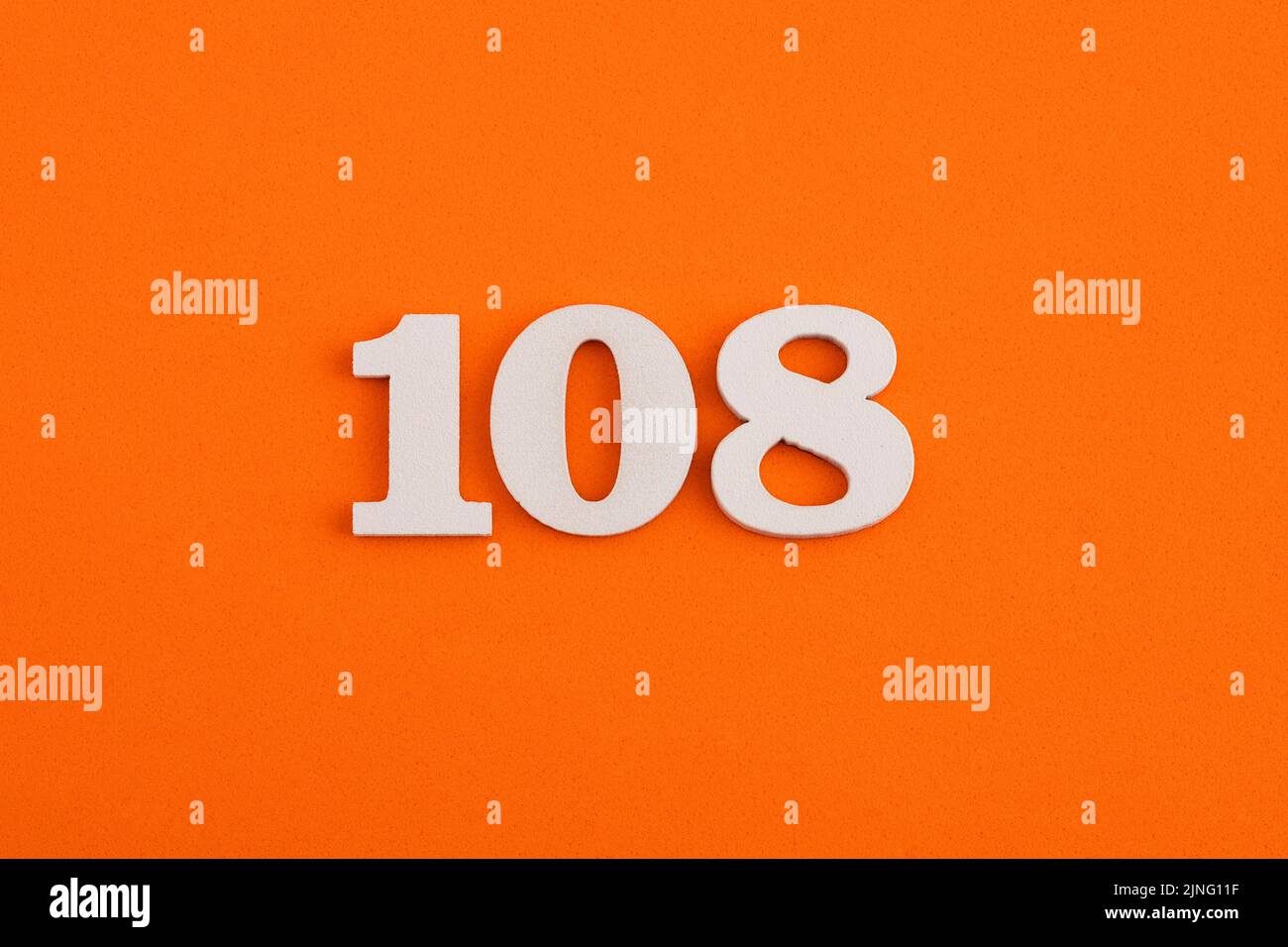 White wooden number 108 on eva rubber orange background Stock Photo - Alamy