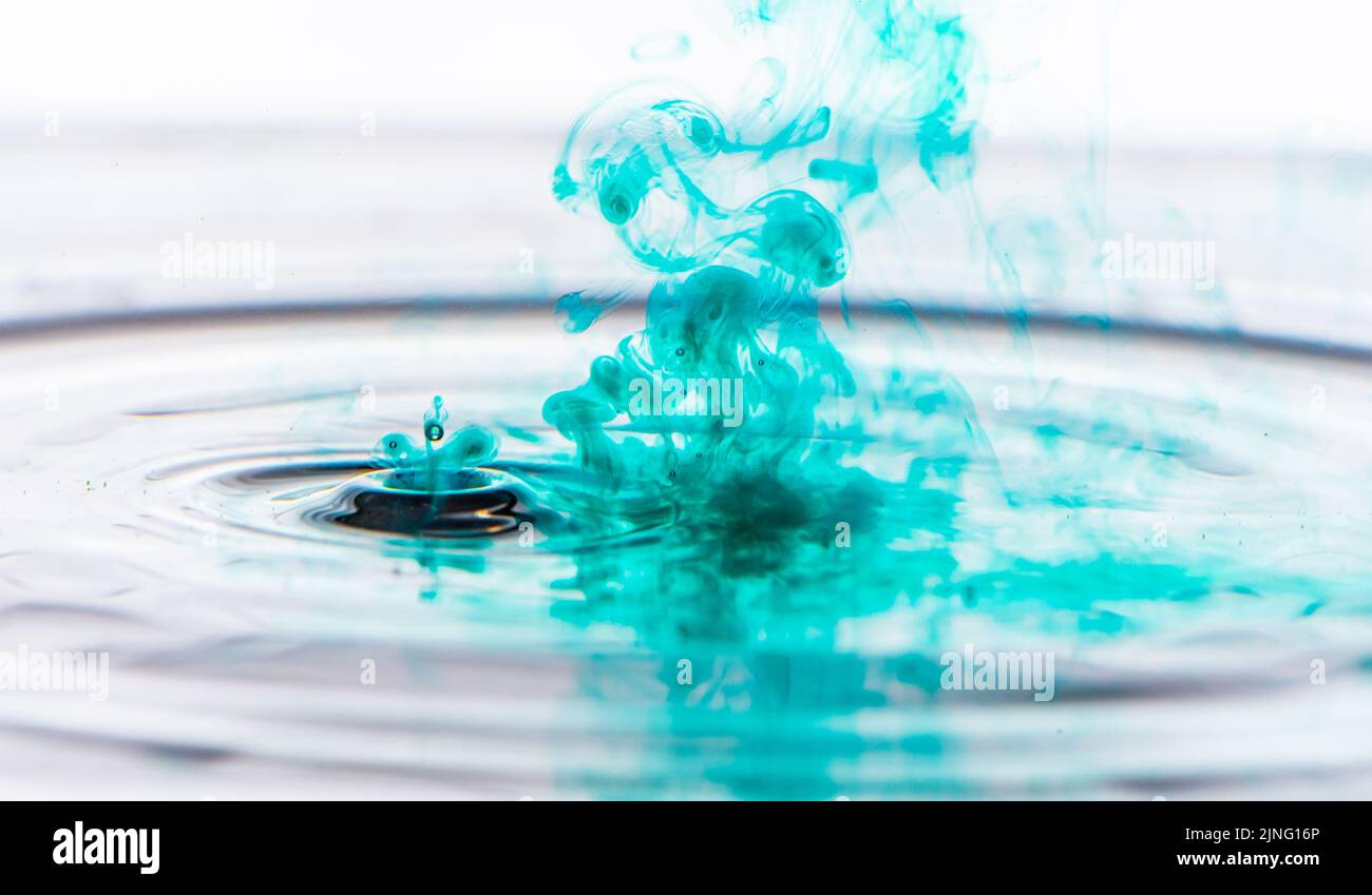 water splash with blue smoke on top Stock Photo - Alamy