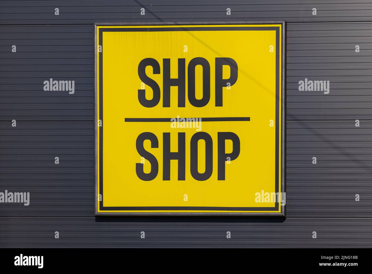 Square Yellow Sign Shop at Building Wall Stock Photo - Alamy