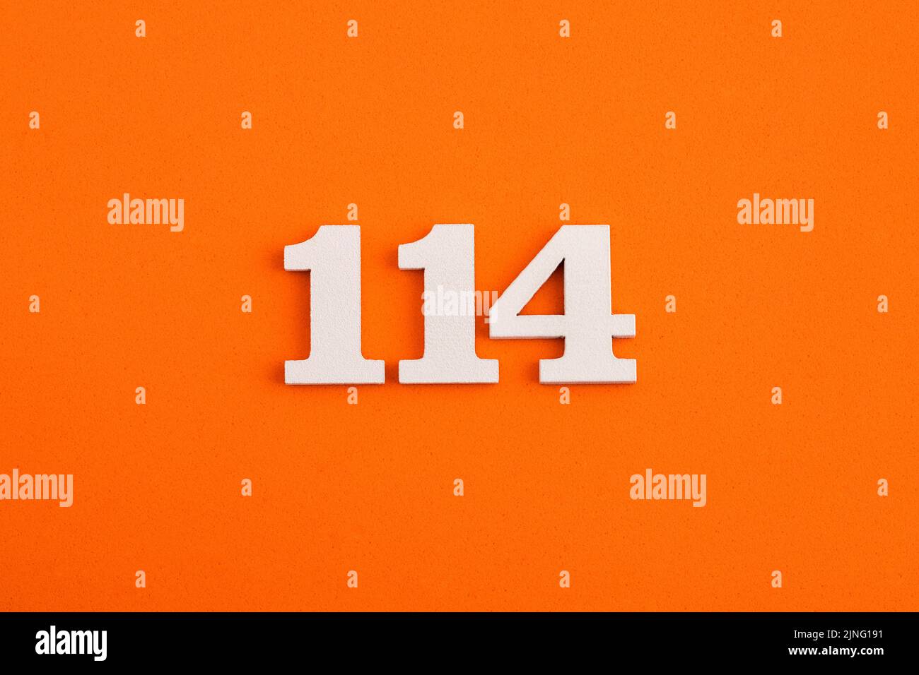 White wooden number 114 on eva rubber orange background Stock Photo - Alamy