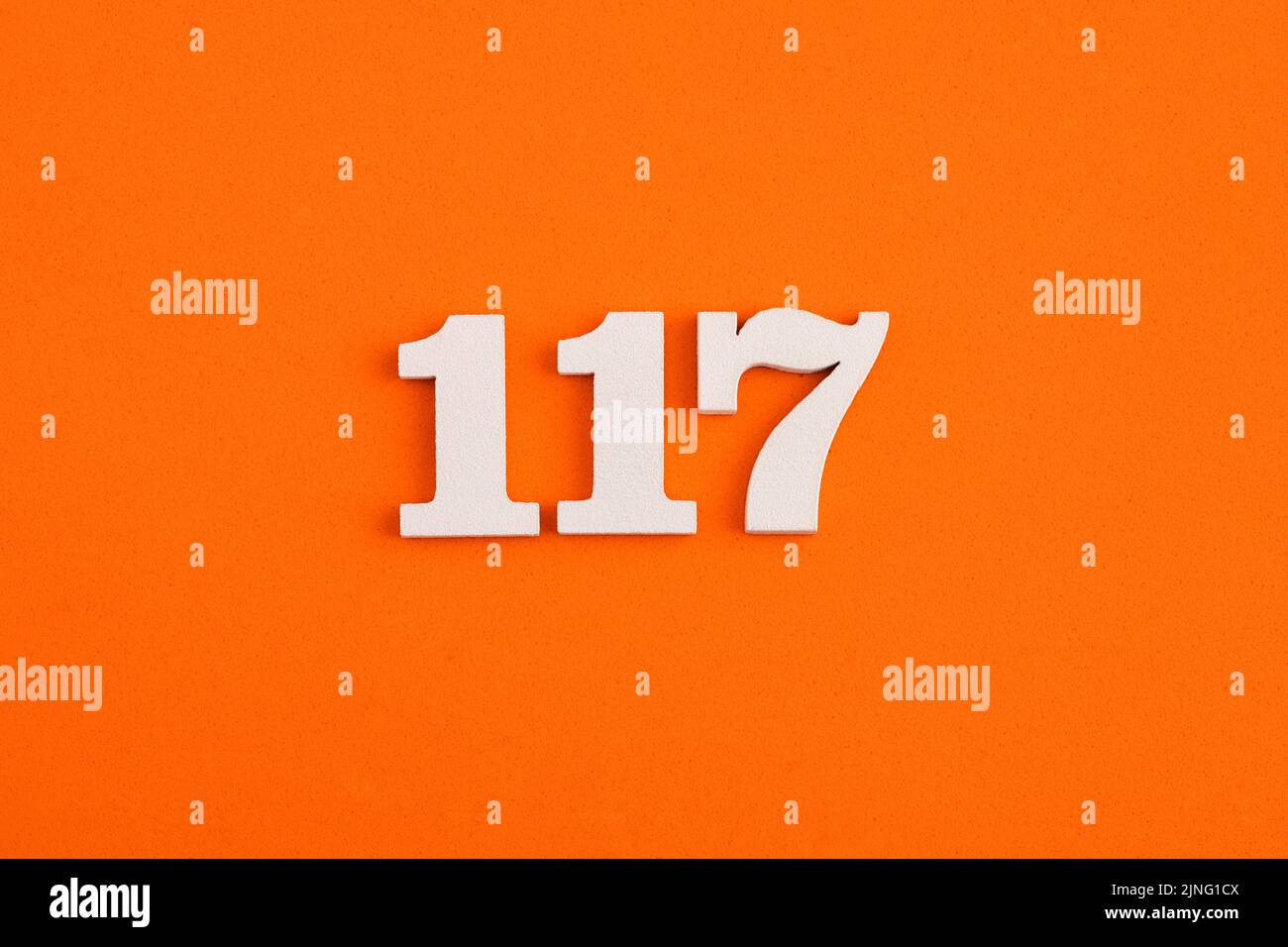 Number 117 - On orange foam rubber background Stock Photo - Alamy