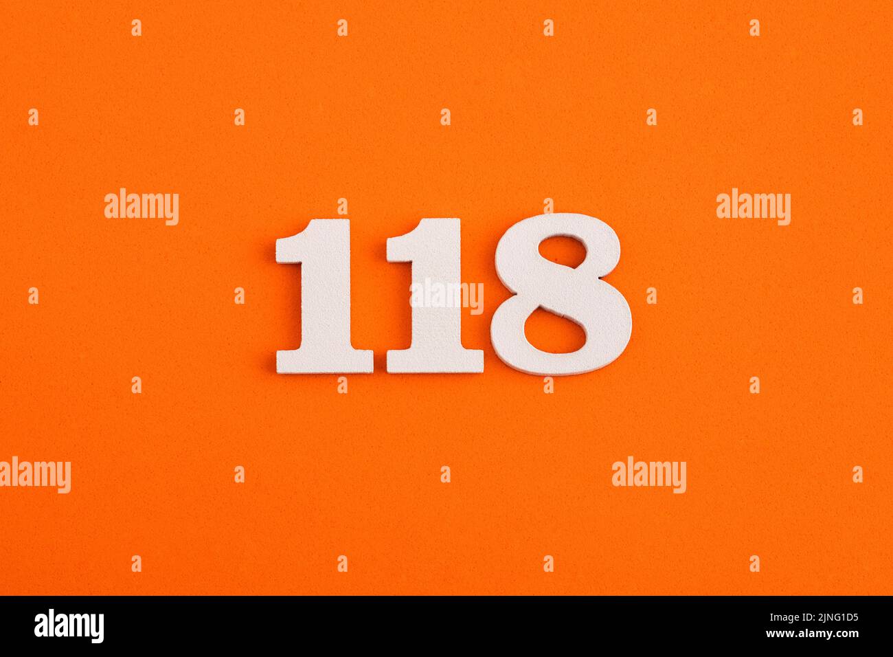 White wooden number 118 on eva rubber orange background Stock Photo - Alamy