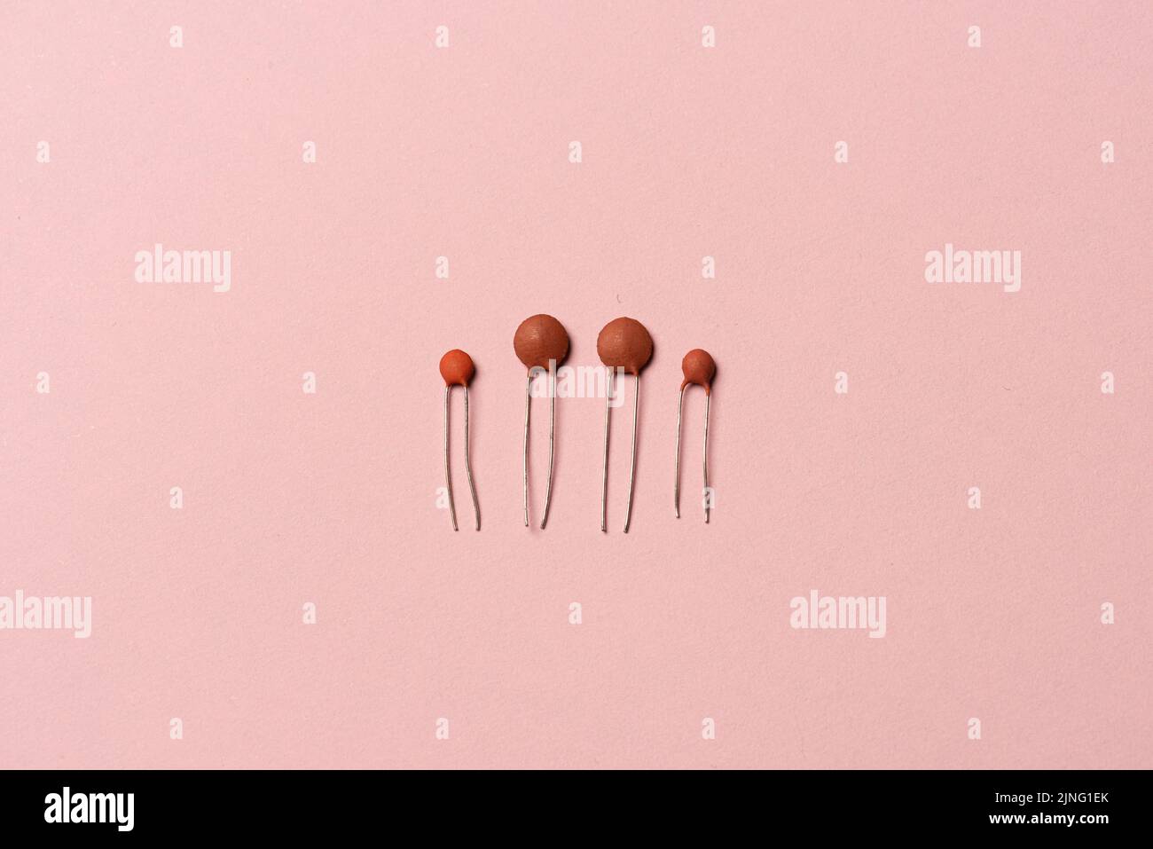 capacitor isolated on a pink background Stock Photo - Alamy