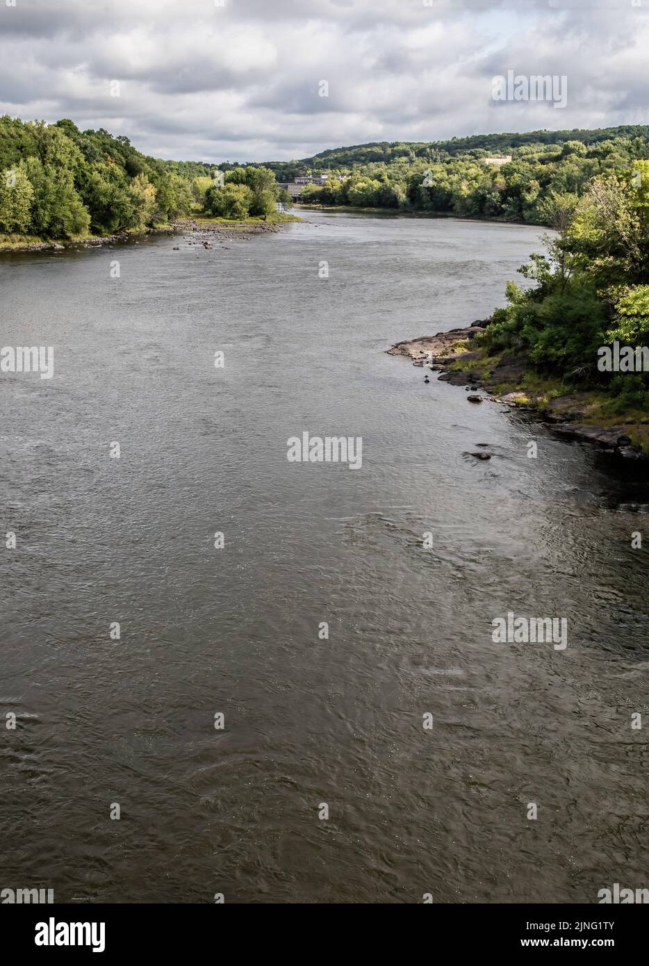 St. Croix River with lush green trees edging the water, lit up by the ...