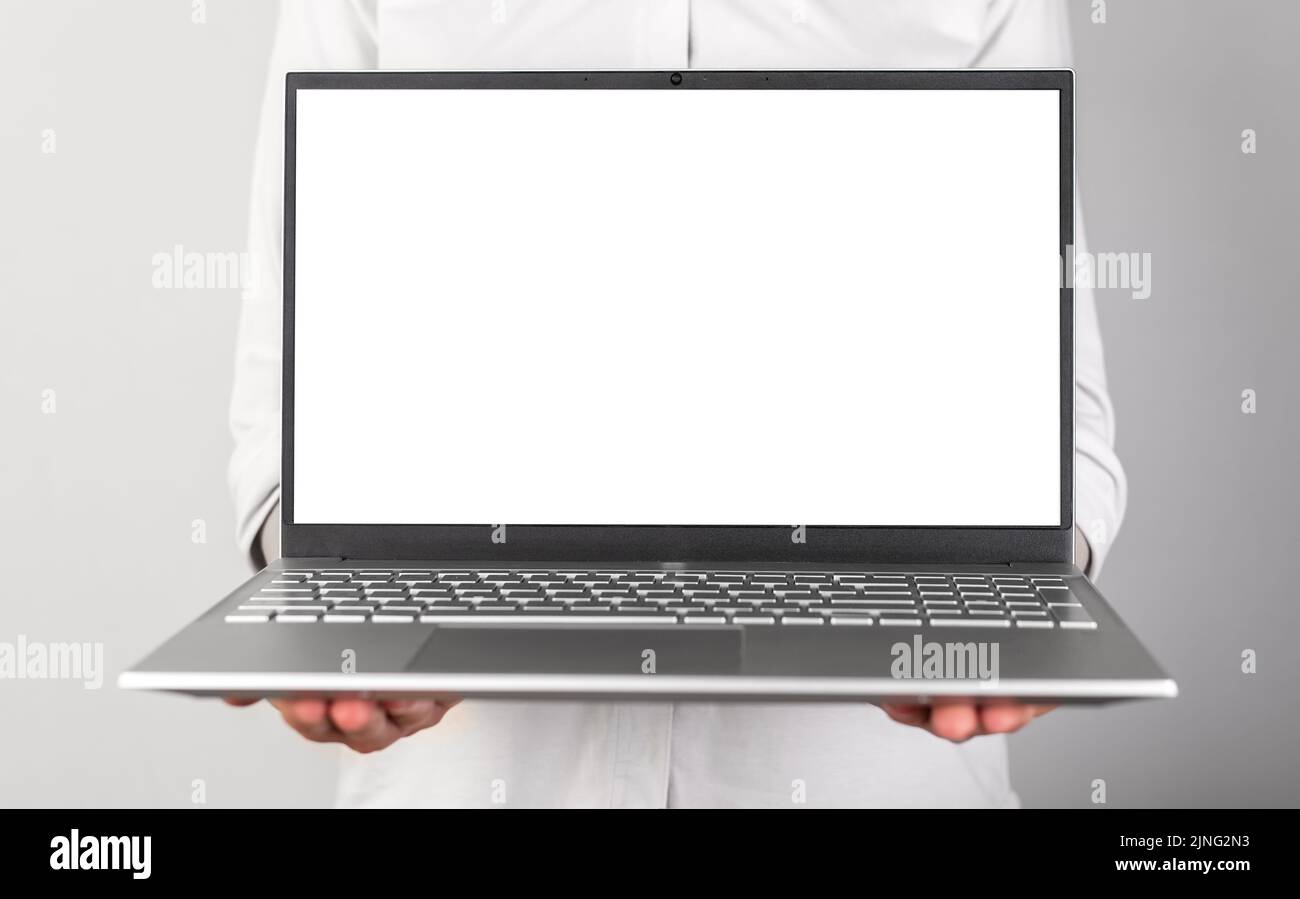 Hands holding laptop mockup with empty display. Person using computer ...
