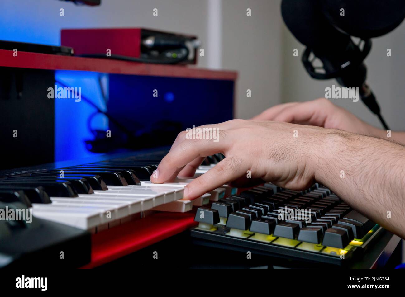 side view closeup of male caucasian hands playing an electric piano in ...
