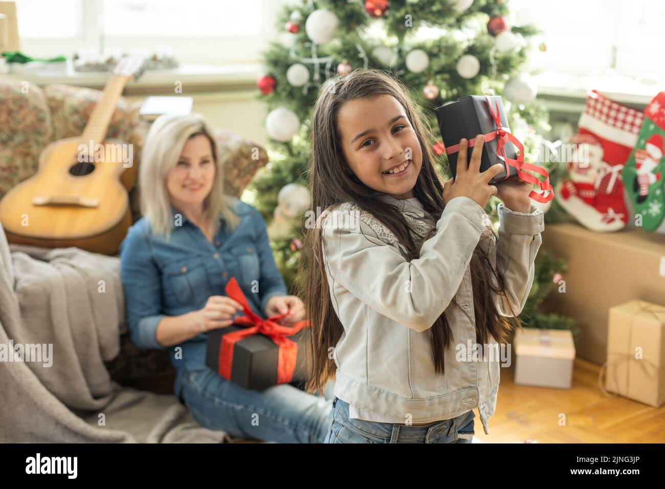 Mother sharing daughter presents hi-res stock photography and images ...