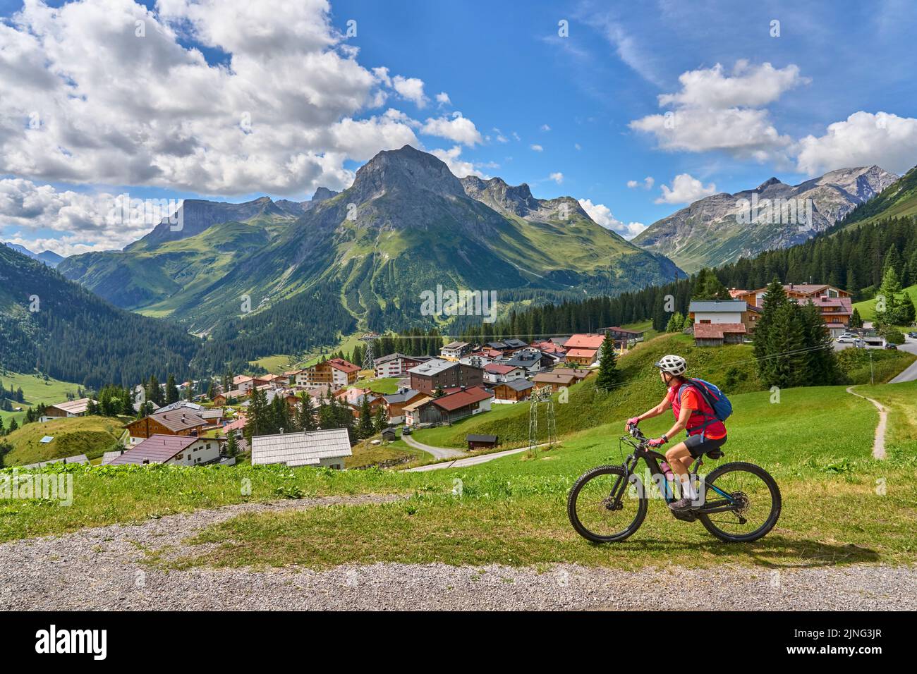active senior woman, riding her electric mountain bike above famous ...