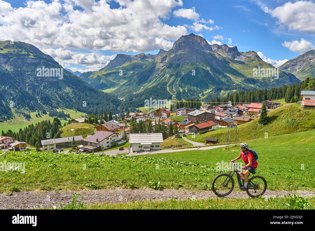 active senior woman, riding her electric mountain bike above famous ...