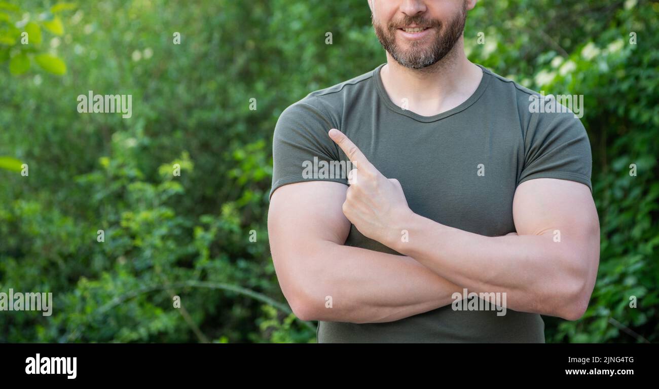 cropped view of man pointing finger. guy pointing finger on copy space ...