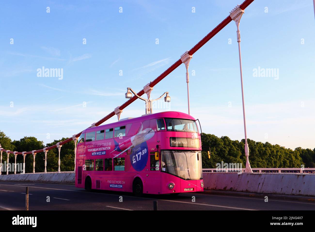 A view of the pink double decker bus on the London Chelsea Bridge Stock ...