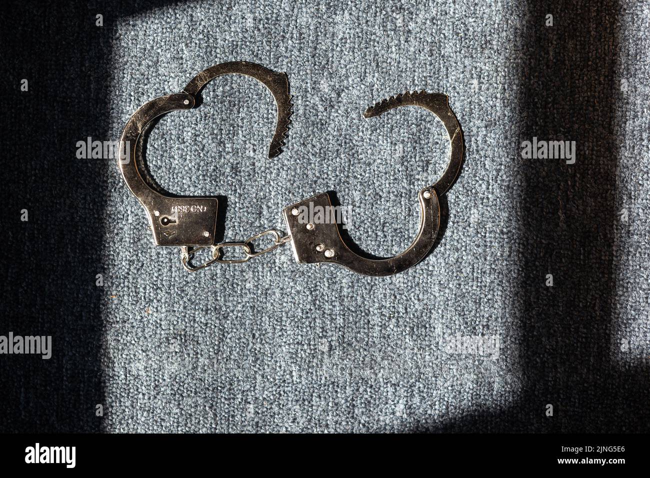 Classic chain handcuffs on black background Stock Photo - Alamy