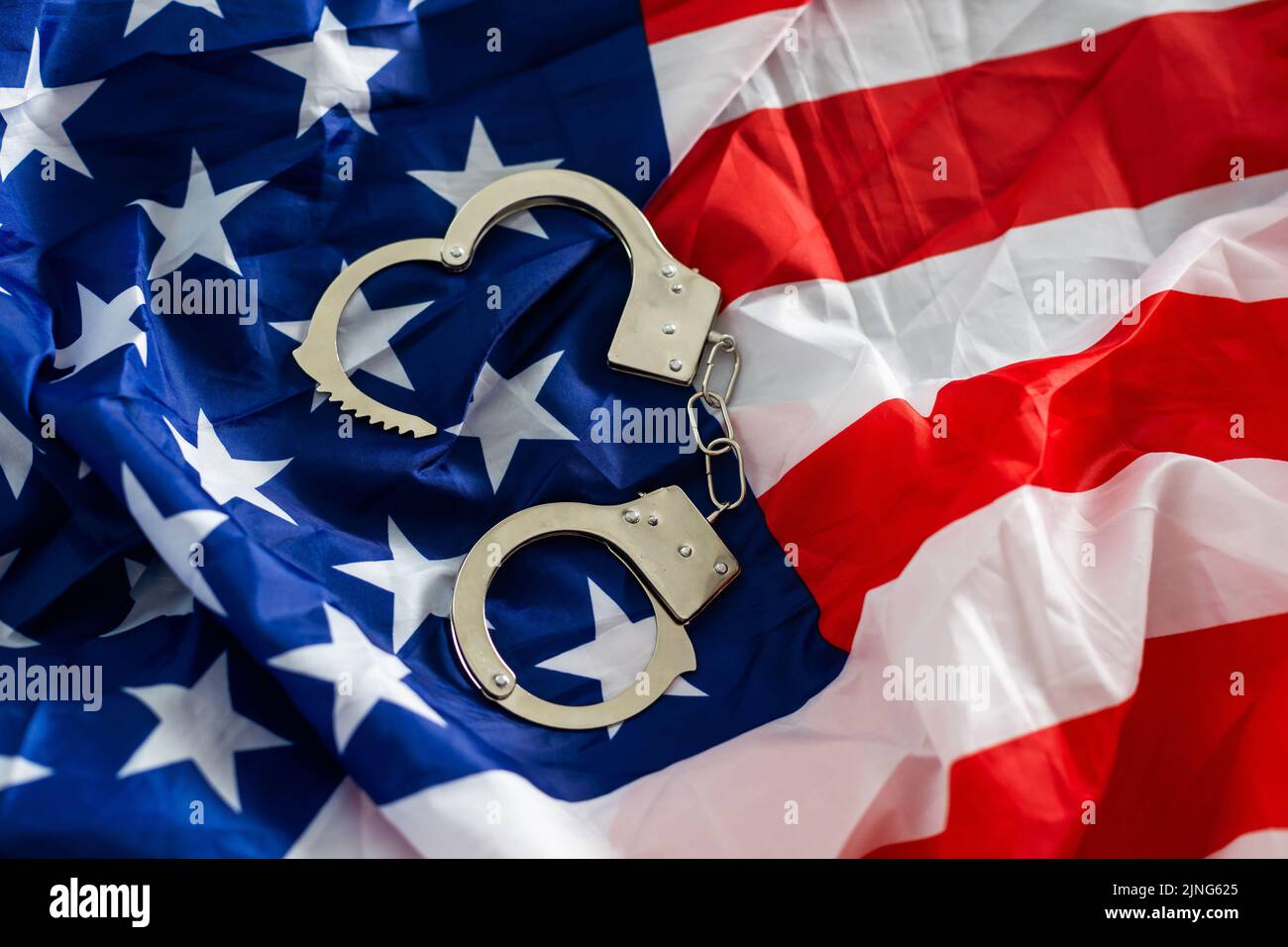 Police handcuffs on the USA flag, close-up Stock Photo - Alamy