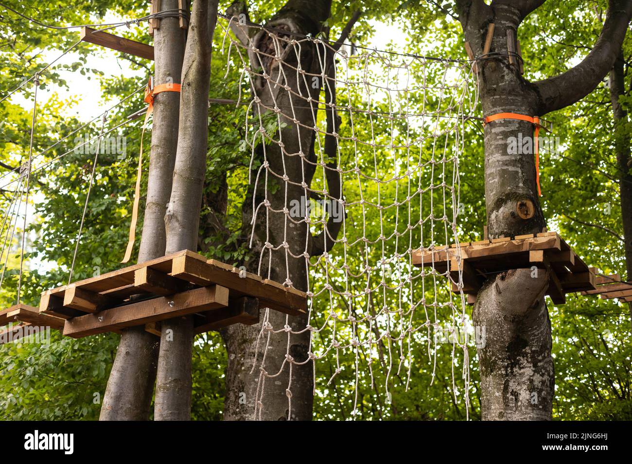 The bridge of logs tied to the ropes, part of a ropes course Stock ...