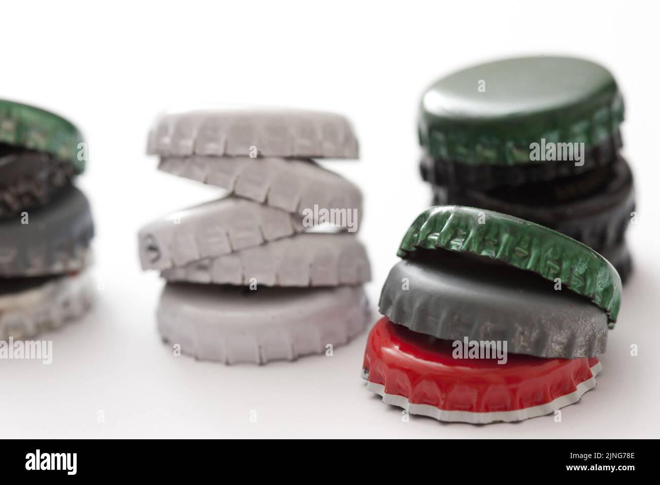 a stack of beer bottle tops on white background Stock Photo - Alamy