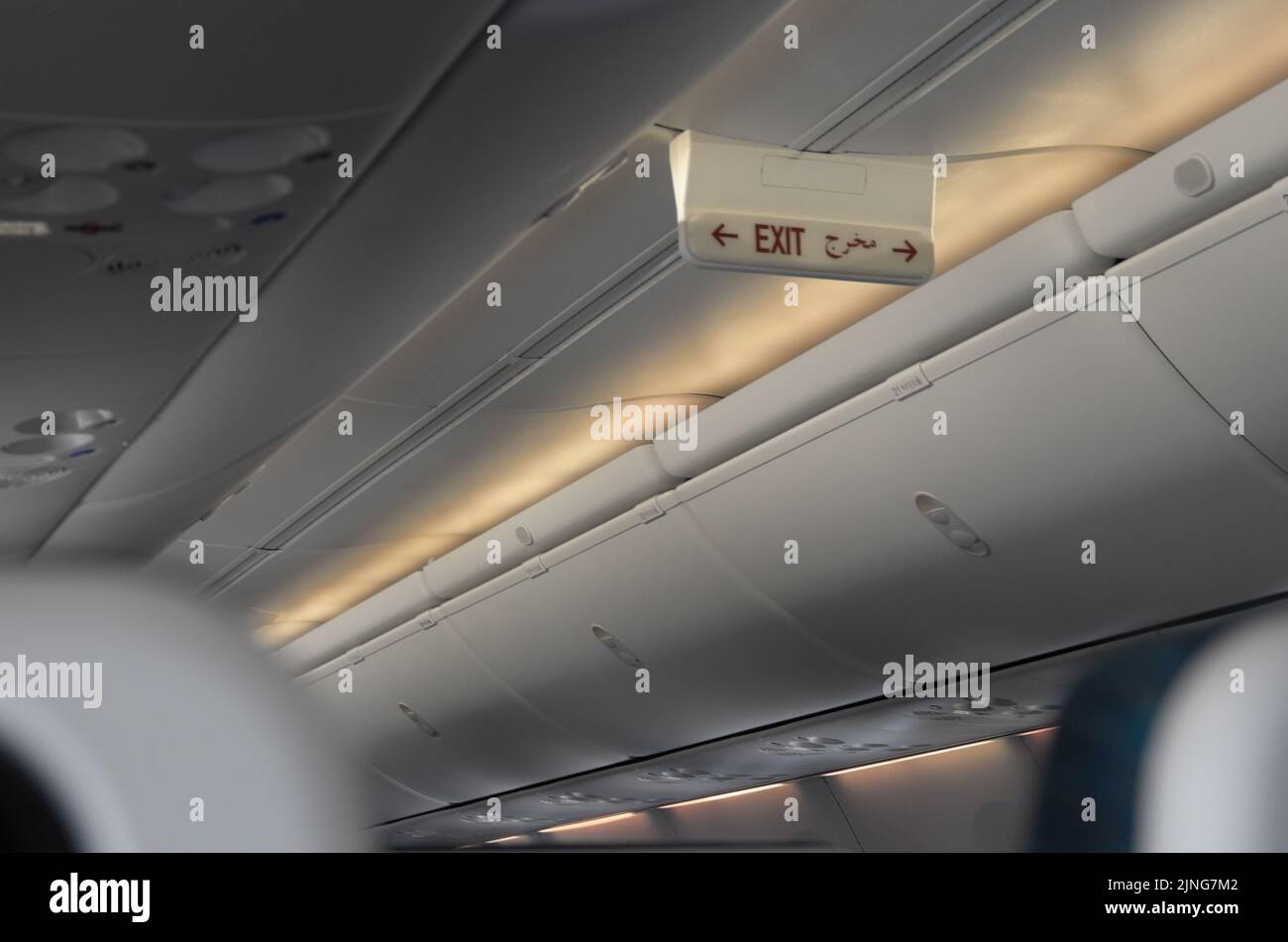 A close-up shot of an emergency exit direction sign in a cabin of an ...