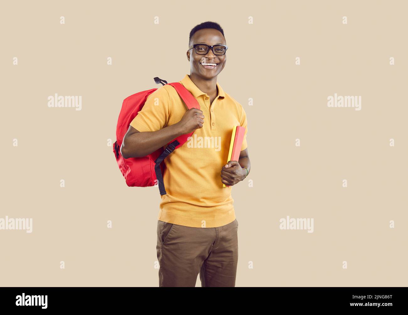 Happy African American student with books and backpack standing on ...