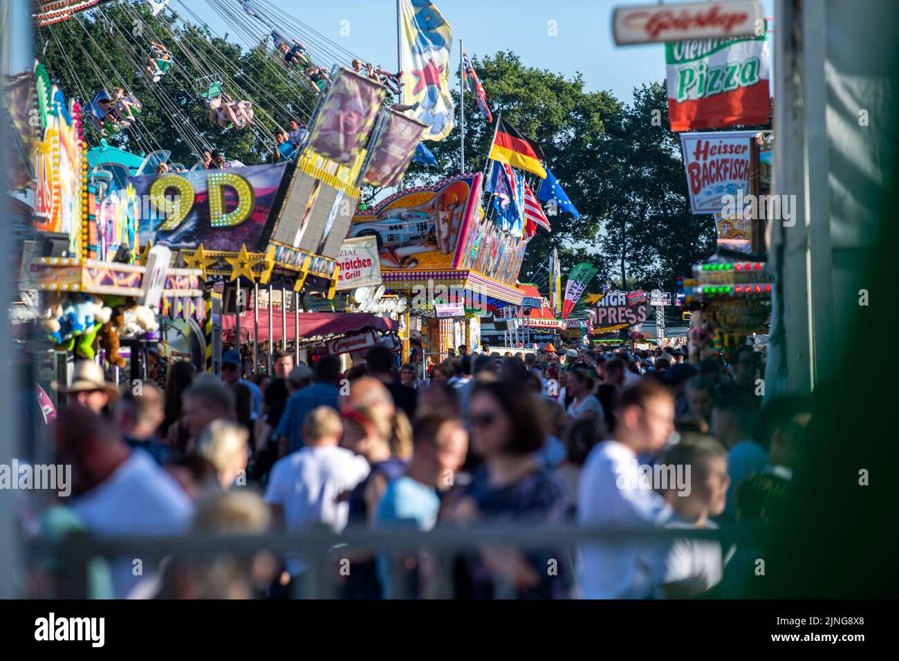 Vechta, Germany. 11th Aug, 2022. People walk between stalls at the ...