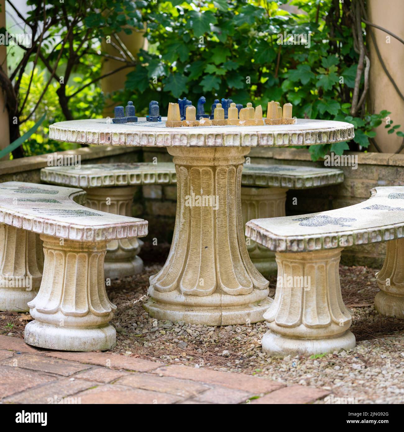 An outdoor stone table with marble stone chess figures on it Stock ...