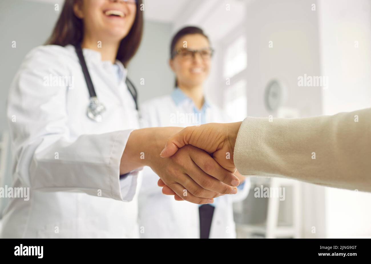 Hands woman doctor and clinic patient making handshake as token of ...