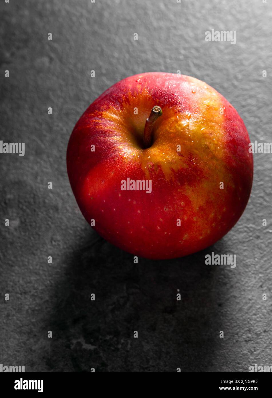 Apples in a dramatic low key concept with a dark background suitable ...