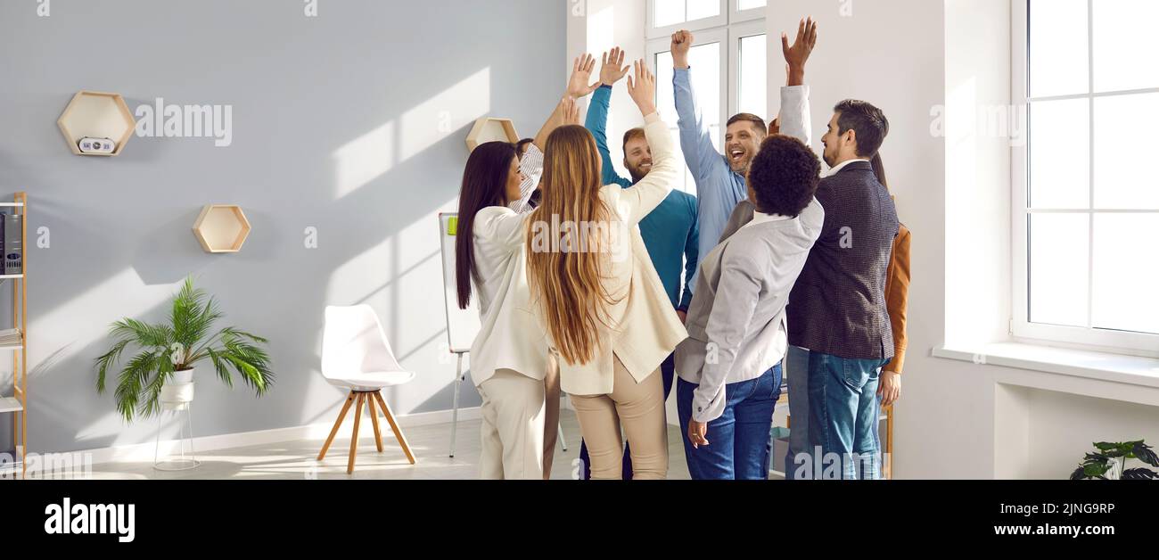Young peoples stand in circle raise their hands up with smile during ...