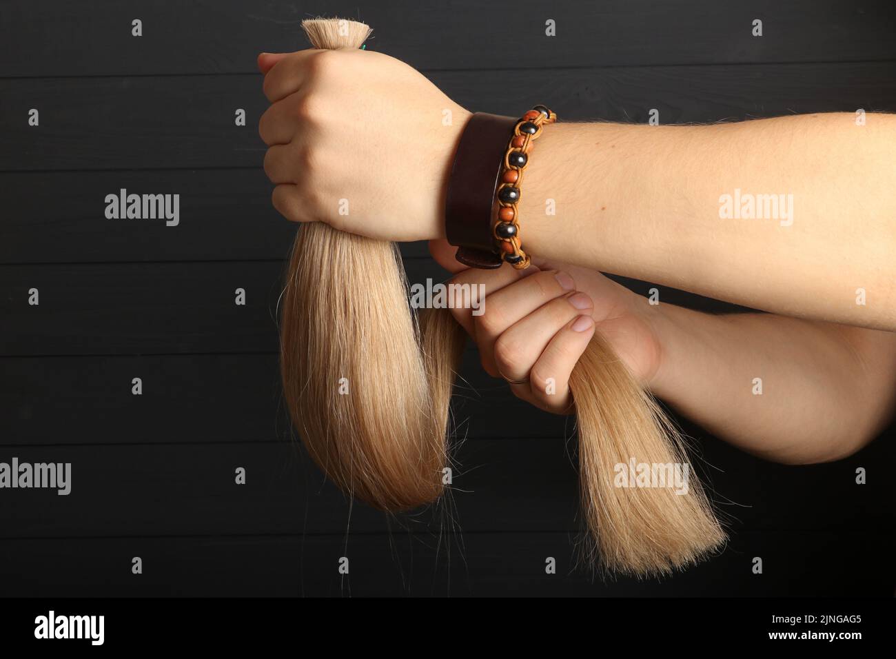 The male hand holds sections of hair for extension Stock Photo - Alamy
