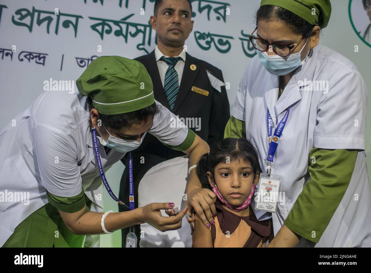 A health worker administers a dose of Pfizer-BioNTech covid-19 vaccine ...