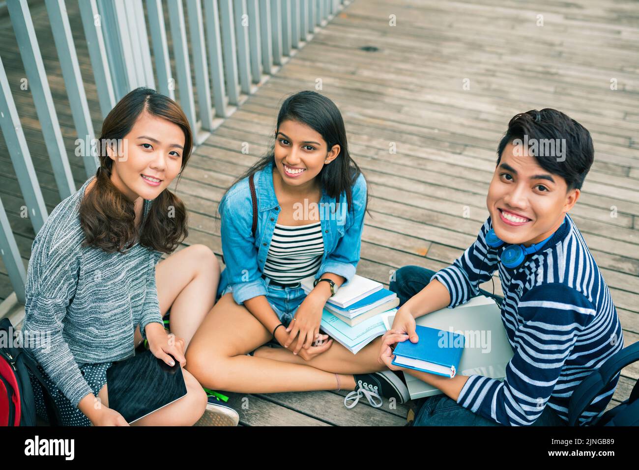 Happy multi-ethnic college students with books looking at camera Stock ...
