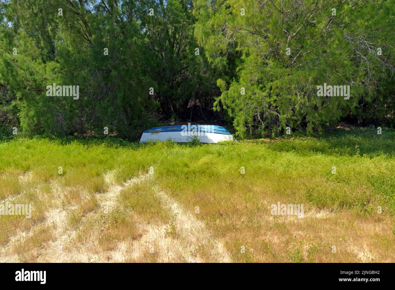 Upturned fishing boat under shade of trees. Countryside view of Tilos ...