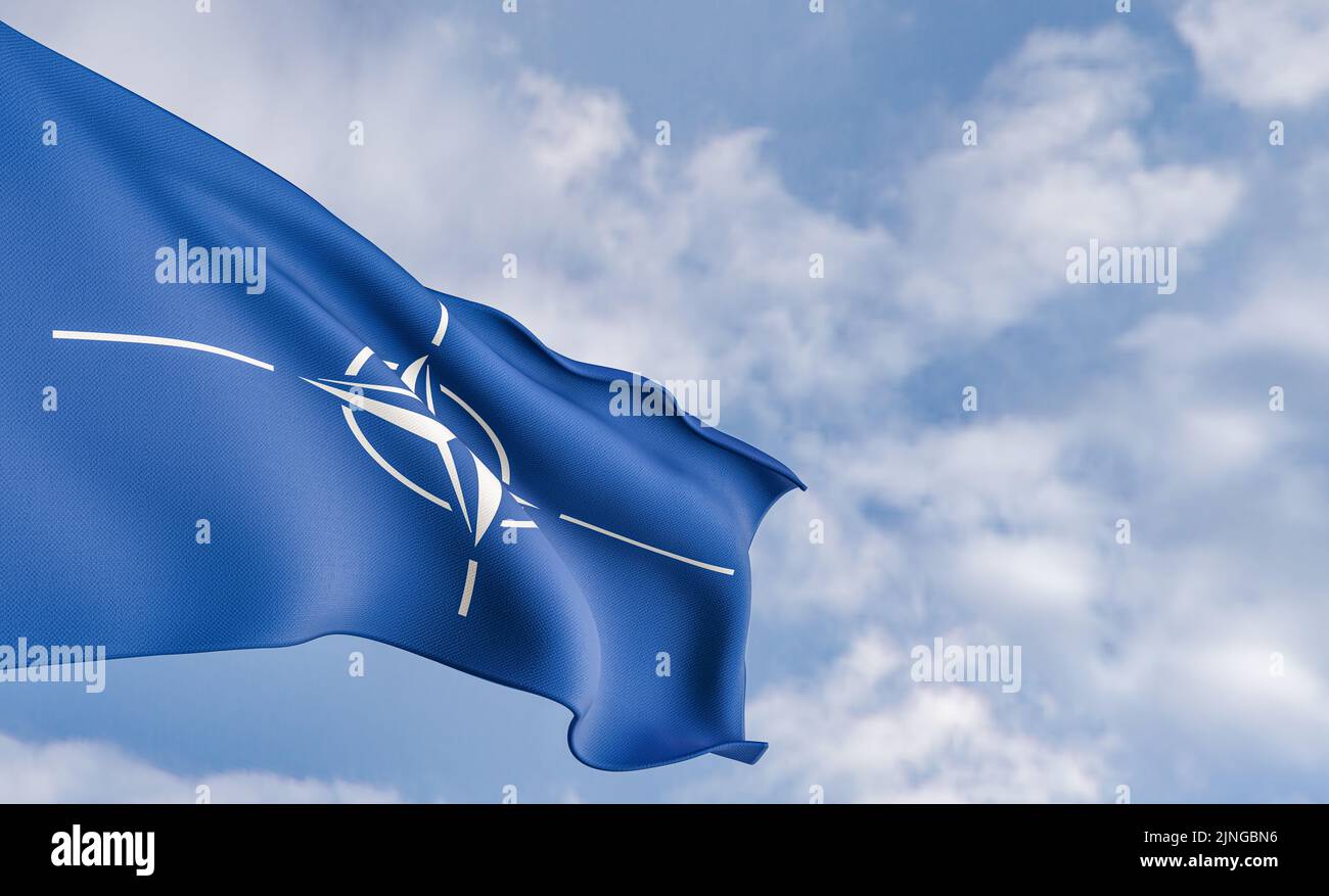 Organization flag NATO on the background of clouds, fabric flag NATO ...