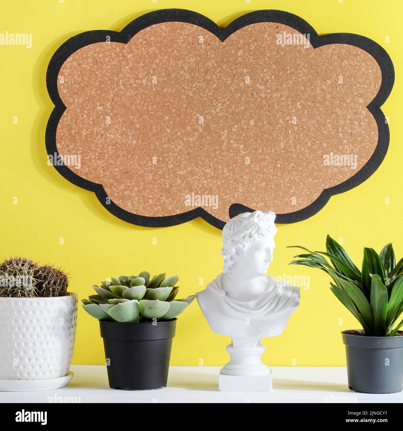 gypsum statue and plants with blank sign on yellow background. copy ...