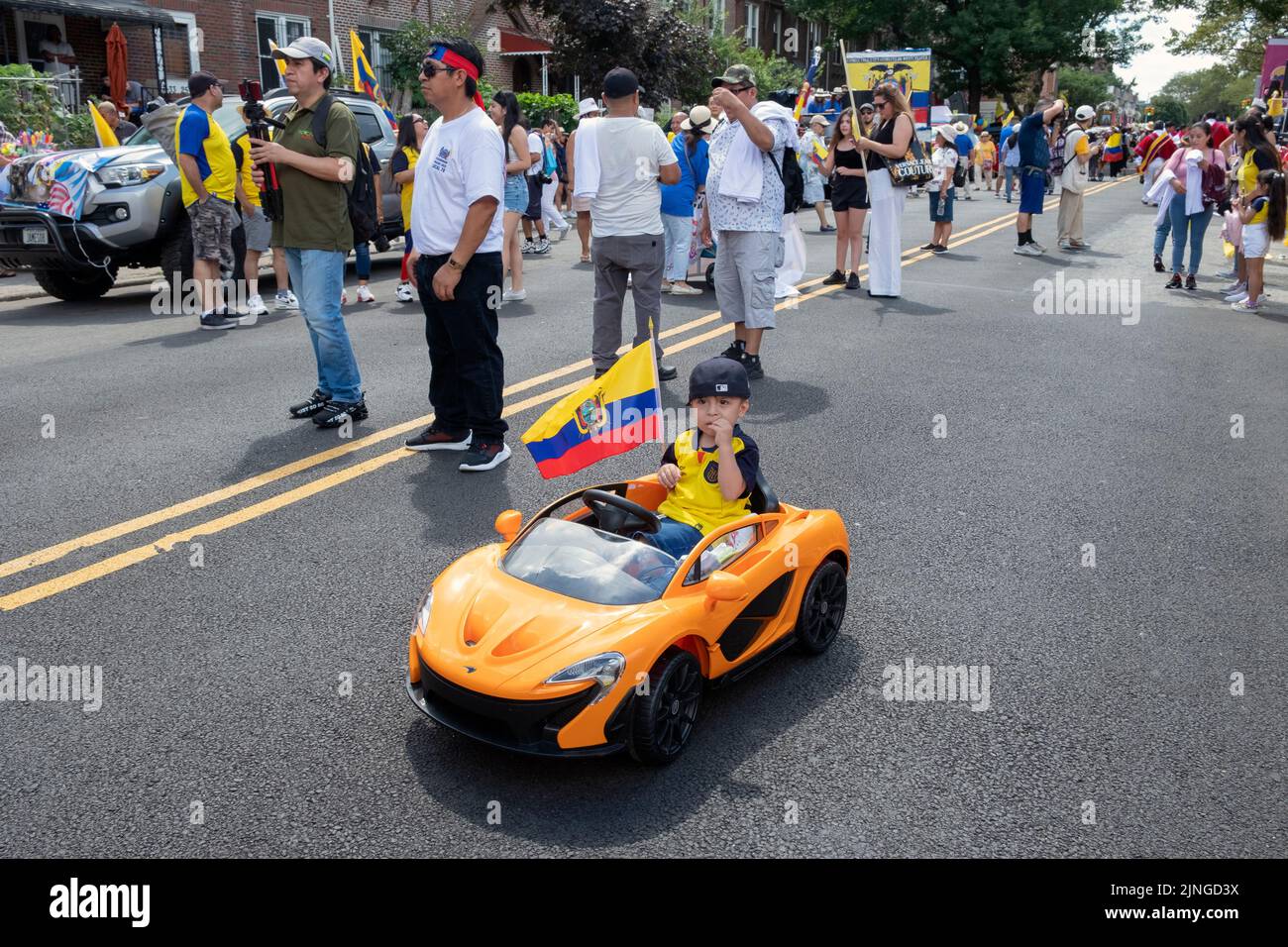 A young Ecuadorian boy rides his electric car on 69th Street just prior ...