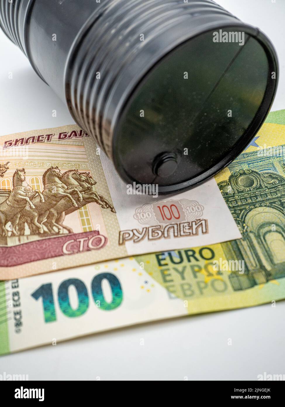 A plastic container for oil storage on a Russian and European currency ...
