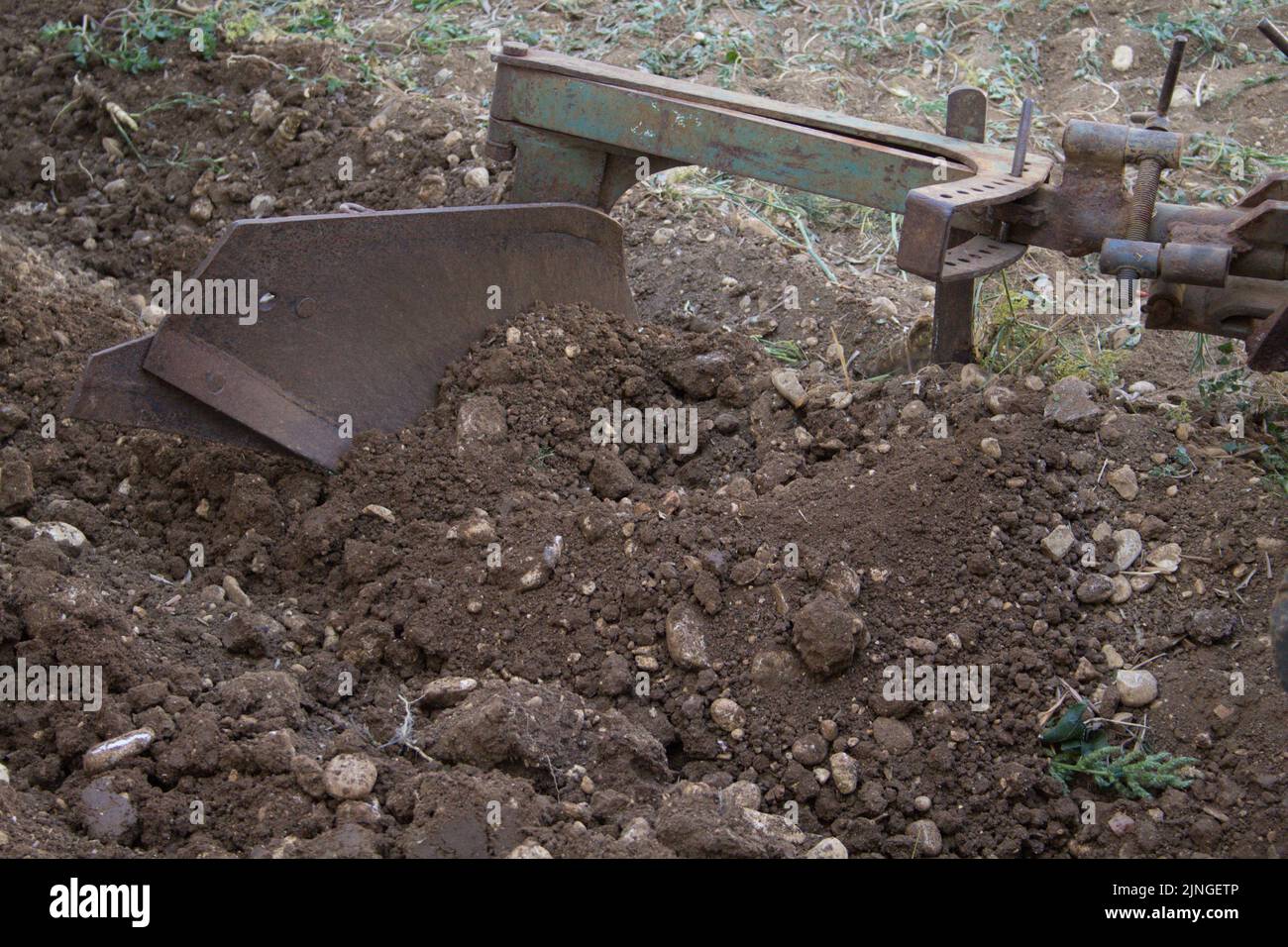 Image of a arratro plowing through the ground. Tillage in agriculture ...