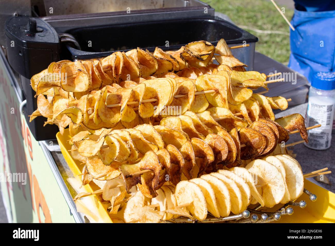 Fried potatoes on a stick close up, street food trade Stock Photo - Alamy