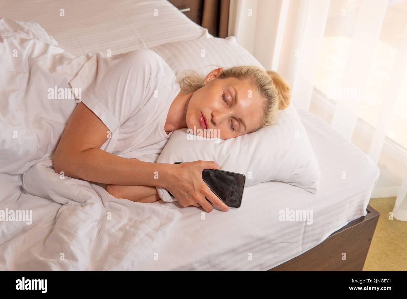 Woman sleep mobile blonde phone beautiful bed blanket view morning, for ...