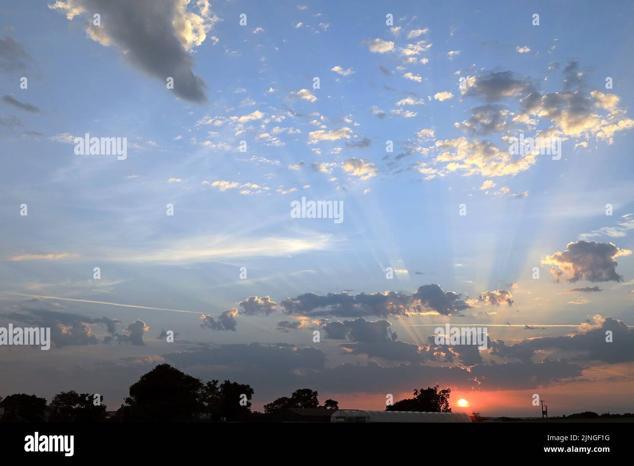 Crepuscular Rays in the Evening Sky Stock Photo - Alamy